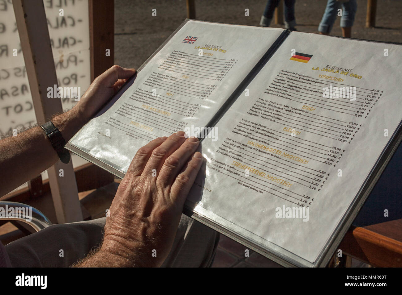 Choosing from the tourist menu in German and English Stock Photo - Alamy