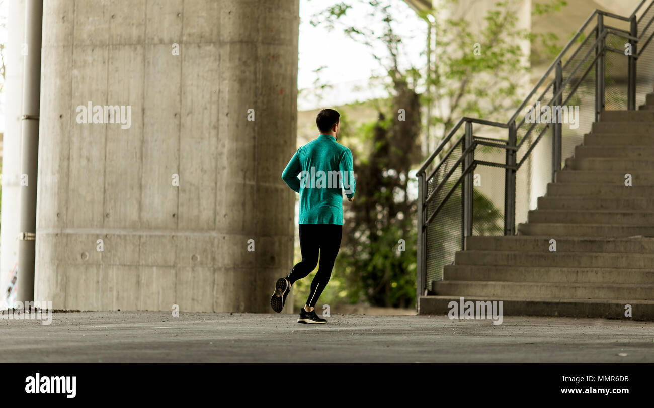 Young man running fast outdoors in the city Stock Photo - Alamy