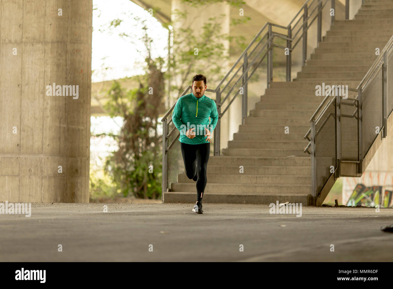 Young man running fast outdoors in the city Stock Photo - Alamy