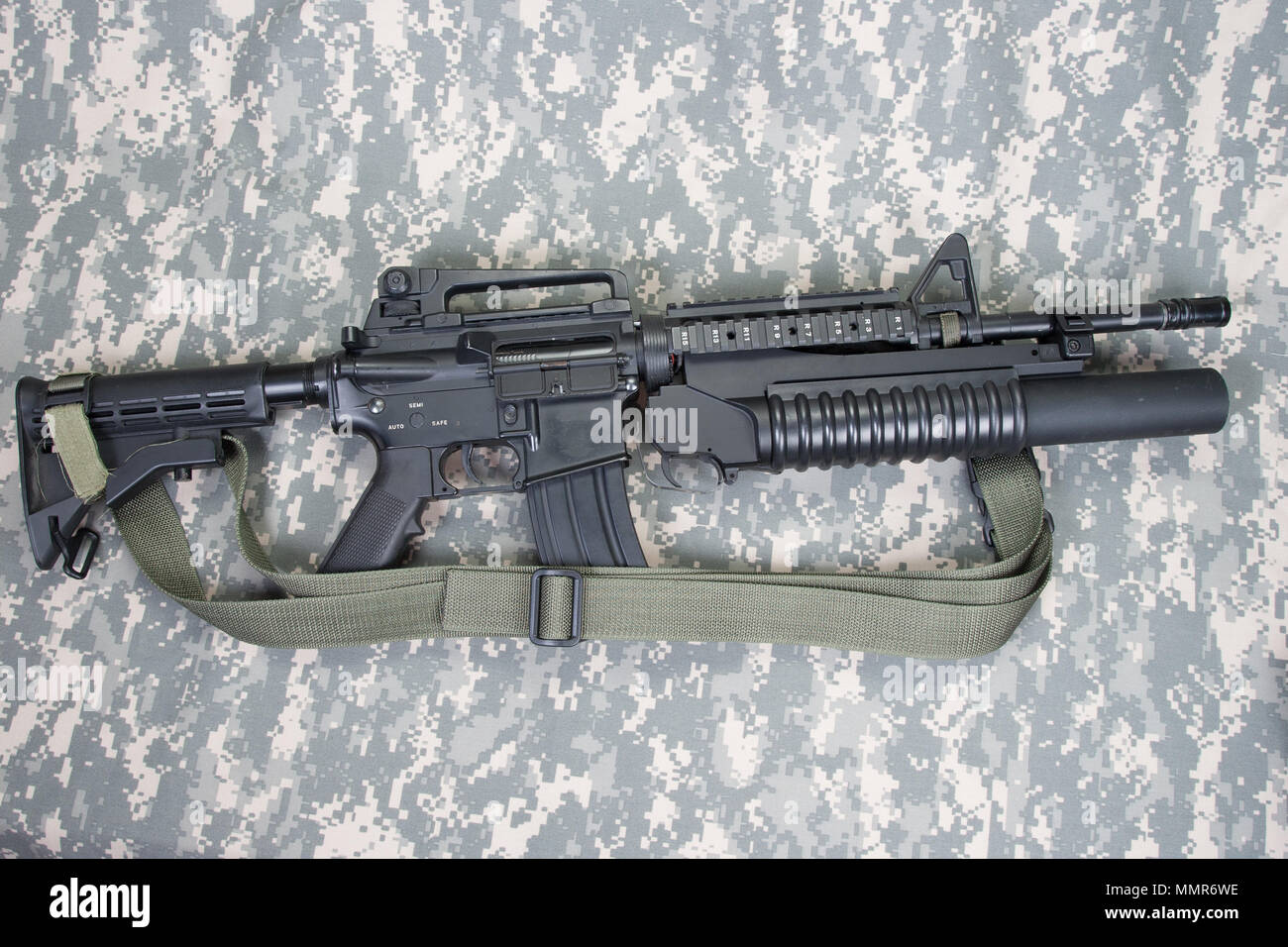 M4A1 carbine equipped with an M203 grenade launcher on ACU camouflage ...