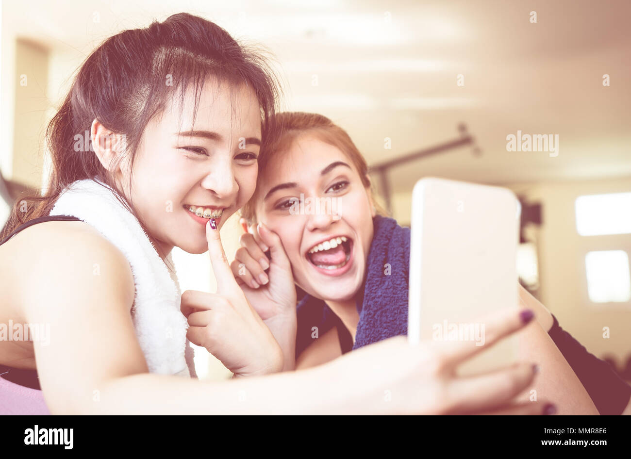 Happy fitness workout friend partner is taking selfie in fitness gym ...