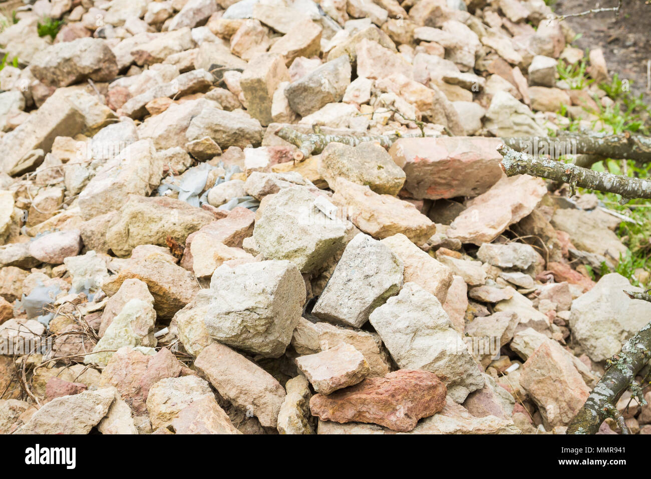 Stones and broken bricks lie in a pile on the street Stock Photo - Alamy