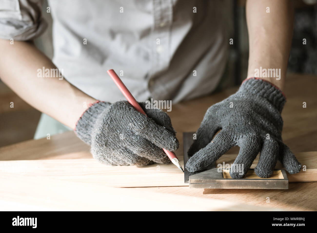 carpenter measuring and writing on wood with copy space background ...