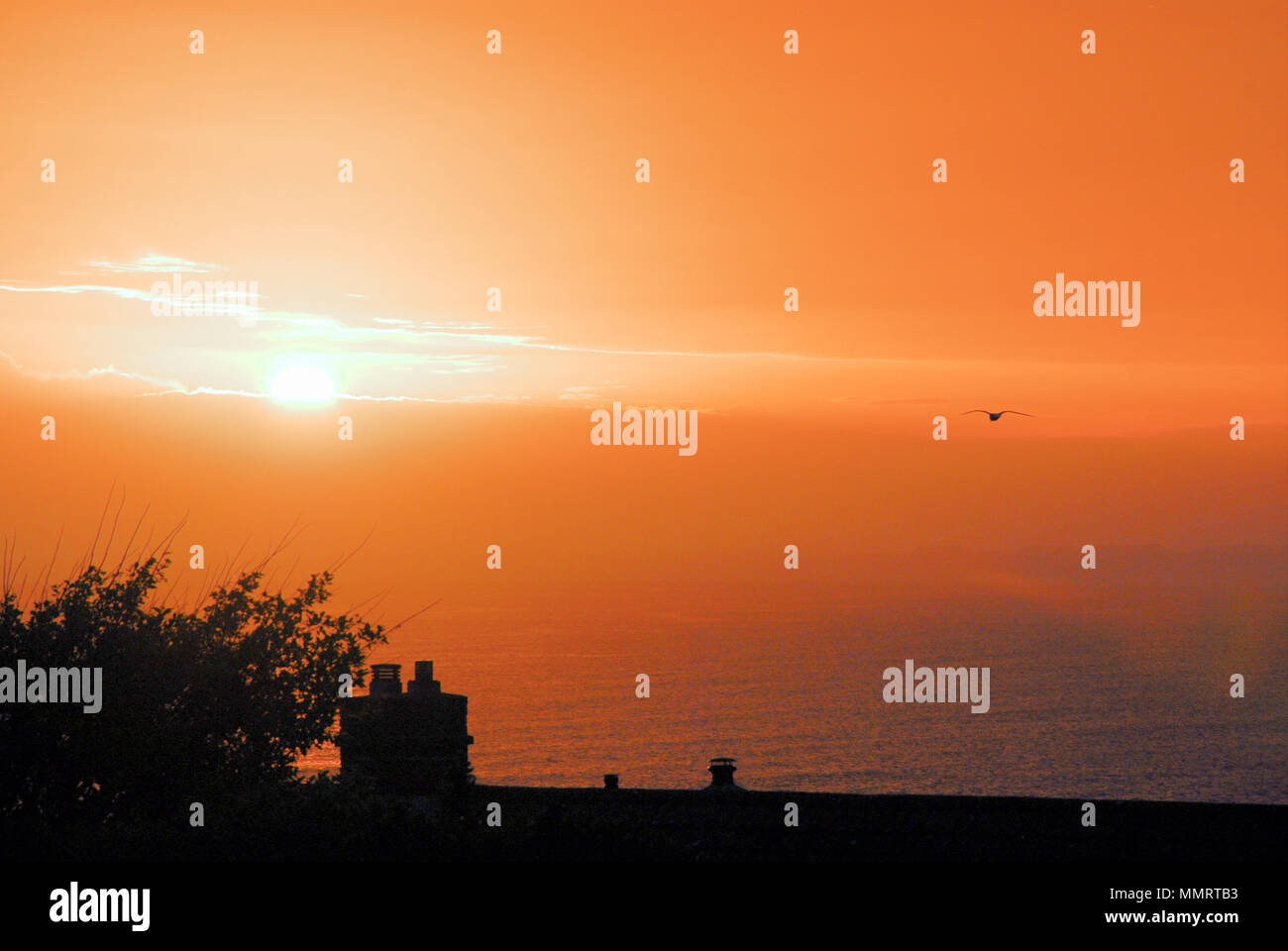 Portland. 12th May 2018.The warm colours of the setting sun over Lyme ...
