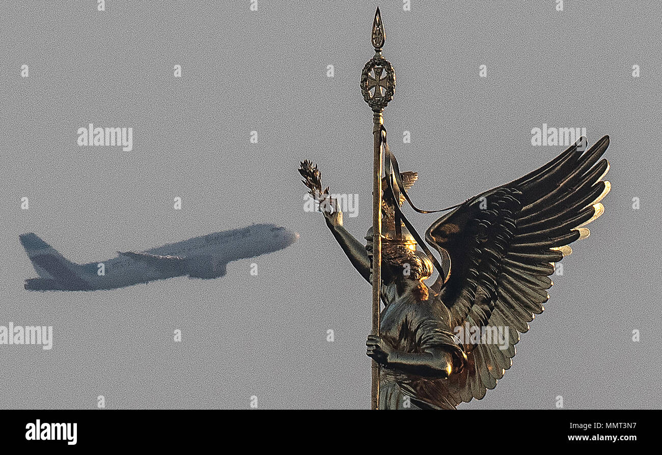 13 May 2018, Germany, Berlin: An airplane takes off in the sky behind a ...