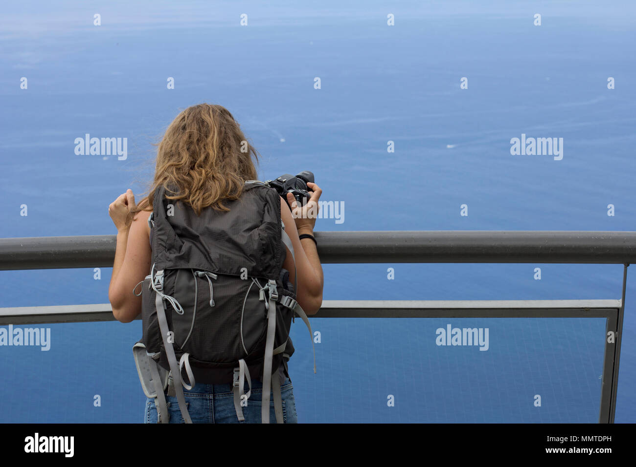 Rear view of a woman with backpack Stock Photo - Alamy