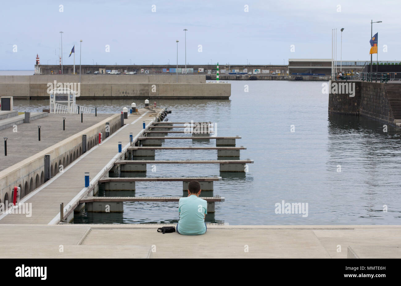 Rear view of an alone boy in a pier Stock Photo - Alamy