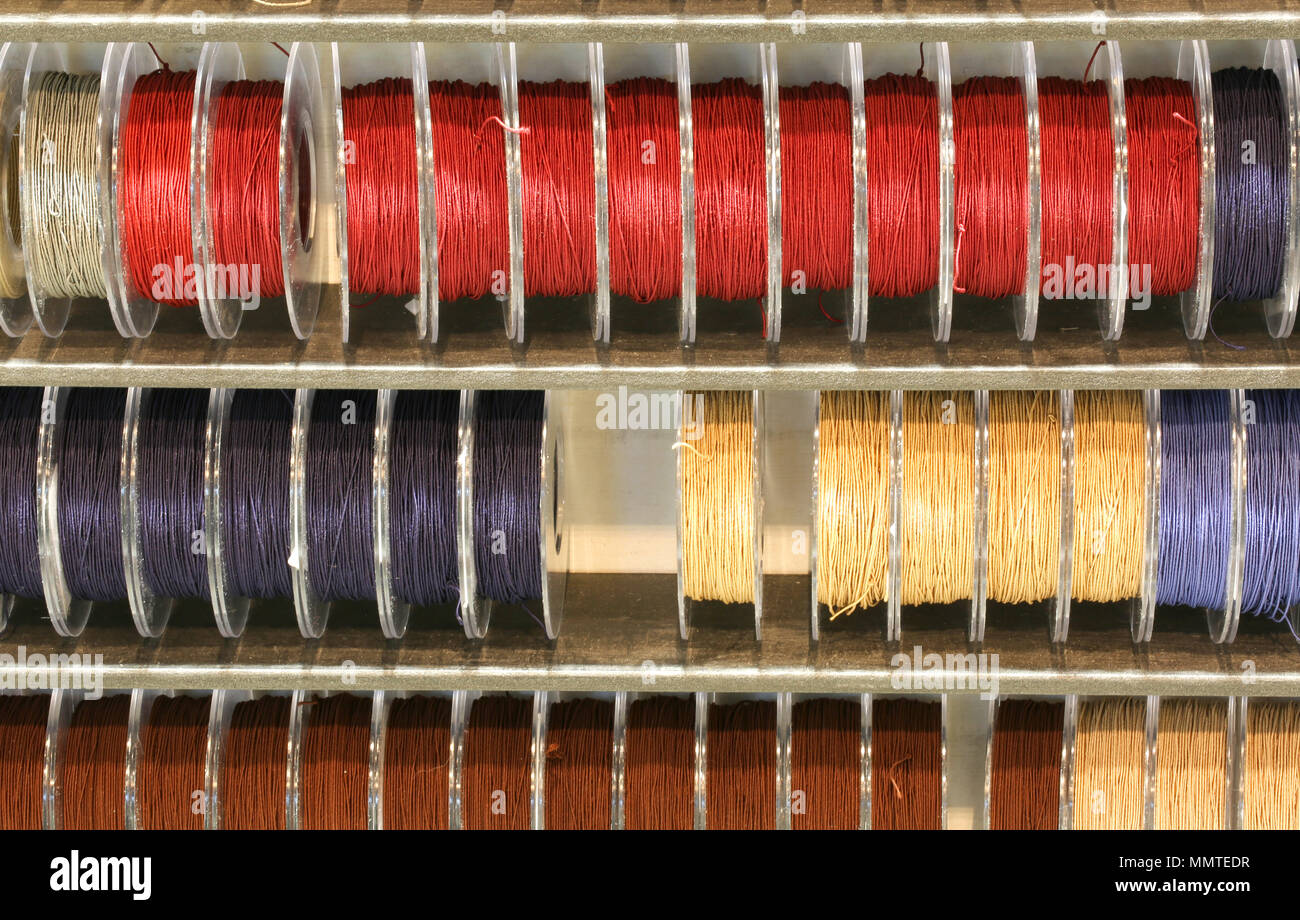 rolls of colored threads on display in a tailor shop and haberdashery ...