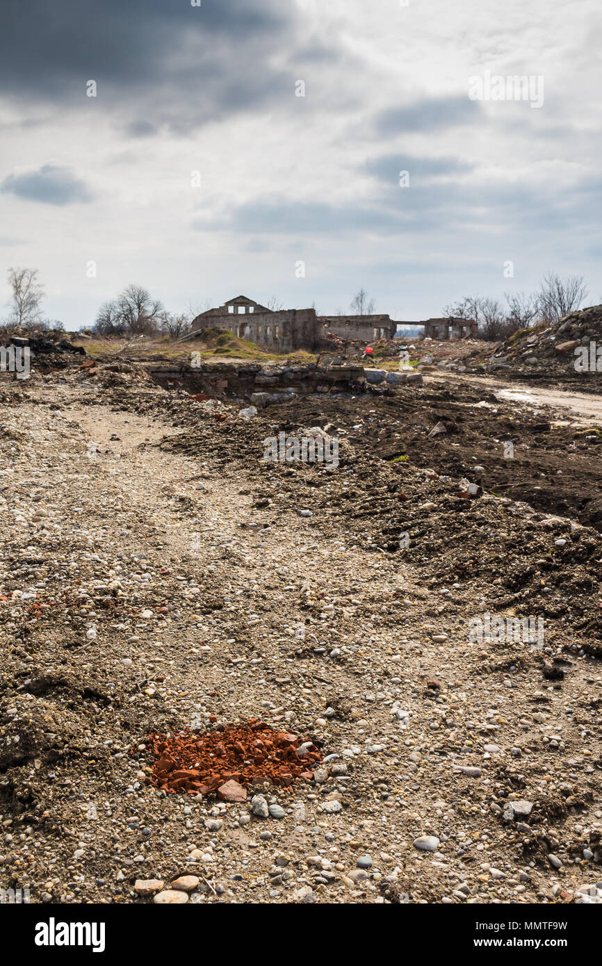 Ground full of stones and with a broken brick. Abandoned house in the ...