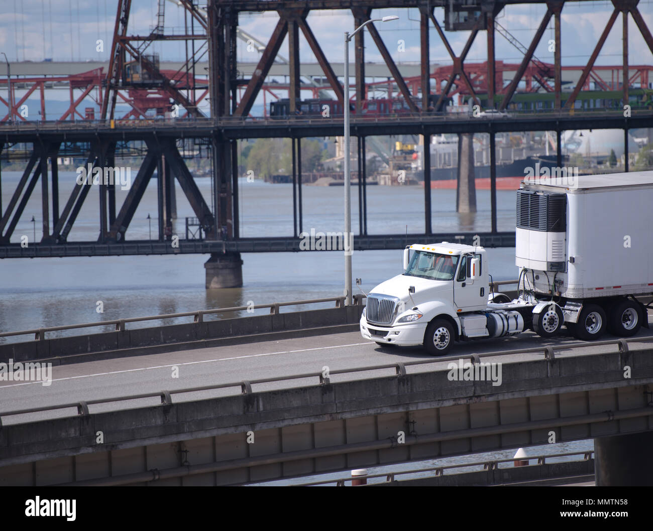 Big rig white day cab semi truck for local delivery transporting cargo ...