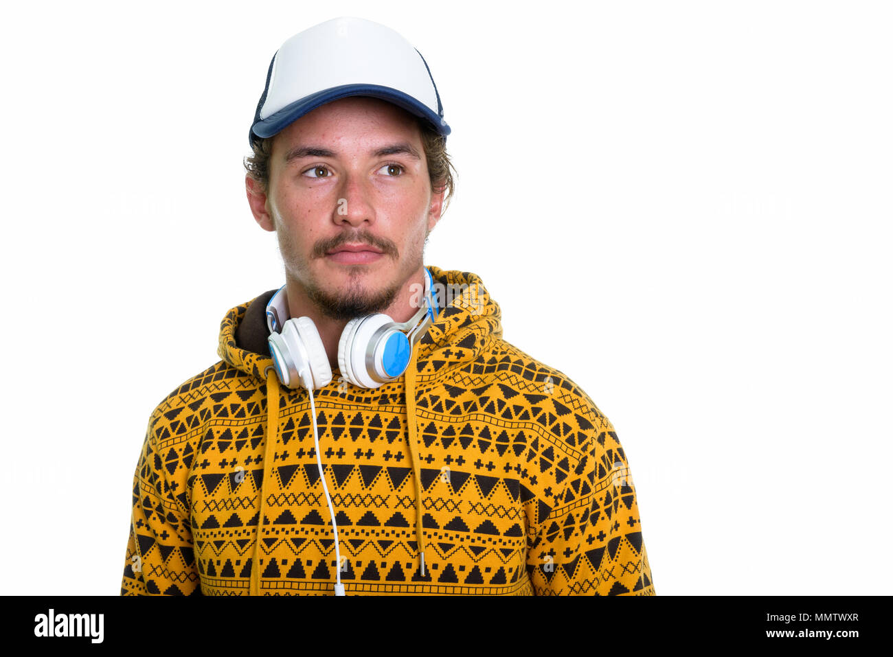 Studio shot of young handsome man thinking while wearing cap and Stock ...
