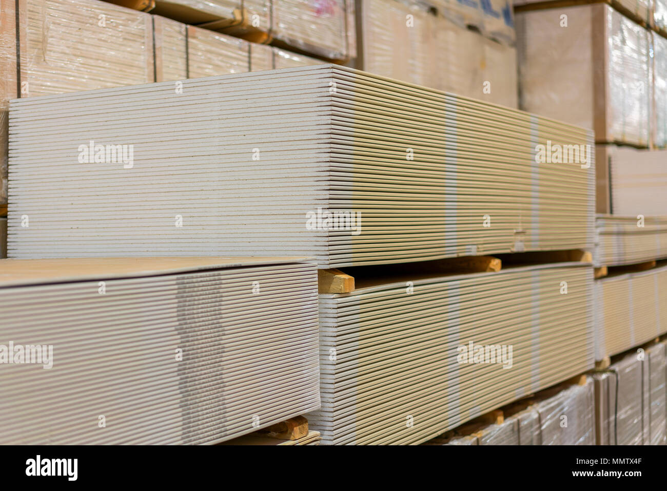 Pallet with plasterboard in the building store Stock Photo - Alamy