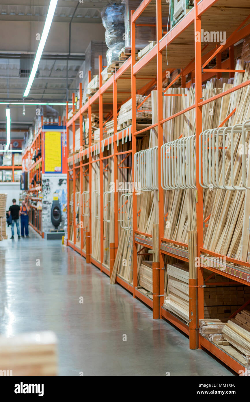 interior of hardware retailer with aisles, shelves, racks of building ...