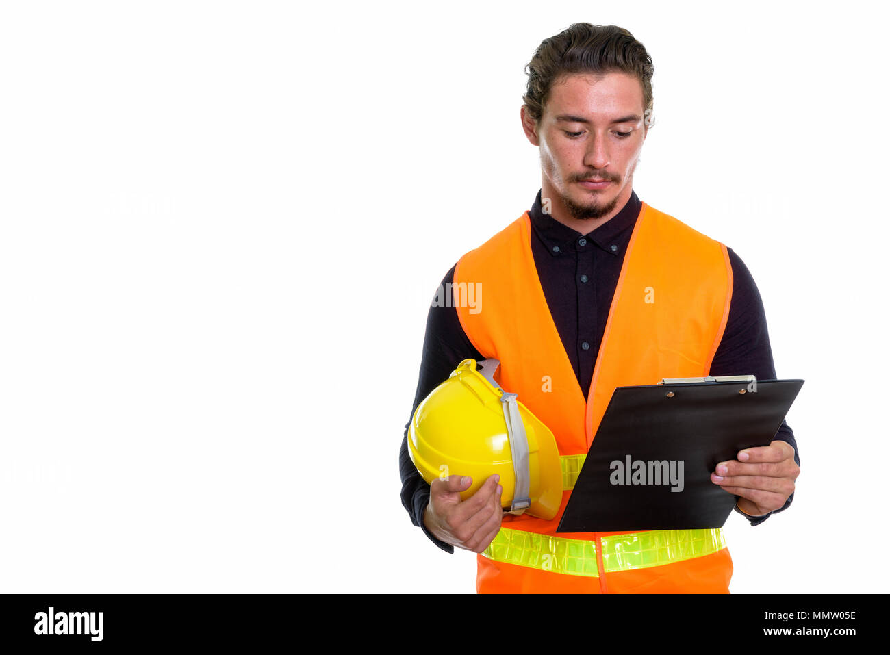 Studio shot of young handsome man construction worker holding ha Stock ...