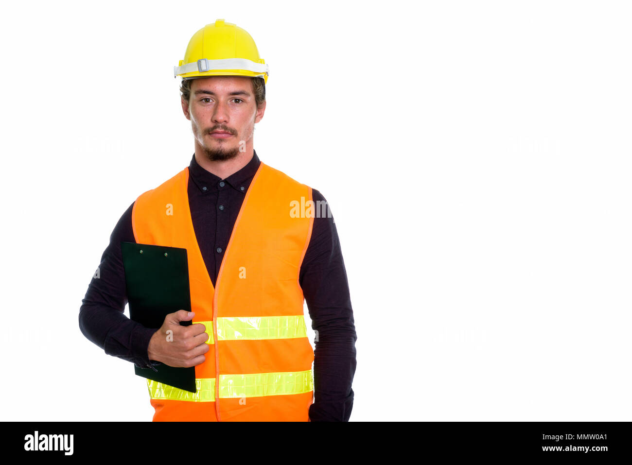 Studio shot of young handsome man construction worker holding cl Stock ...