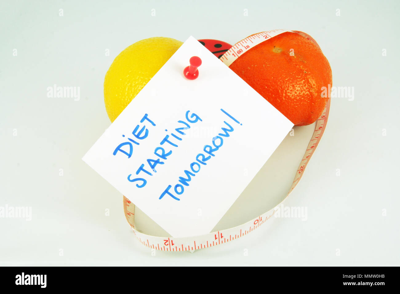 Fresh fruit and note. Healthy nutrition. Fruits, note and a tape meter ...