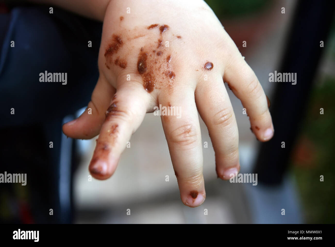 Kids hand smudged with chocolate cookie. Kids hand and chocolate cream ...
