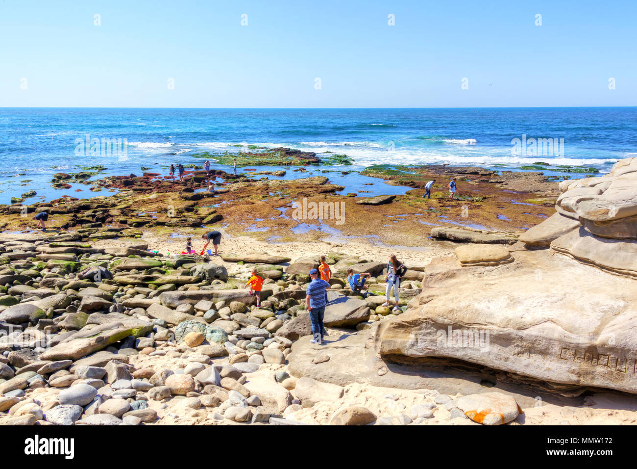 SAN DIEGO, UNITED STATES - MAR 27, 2018: Visitors meander the beach at ...