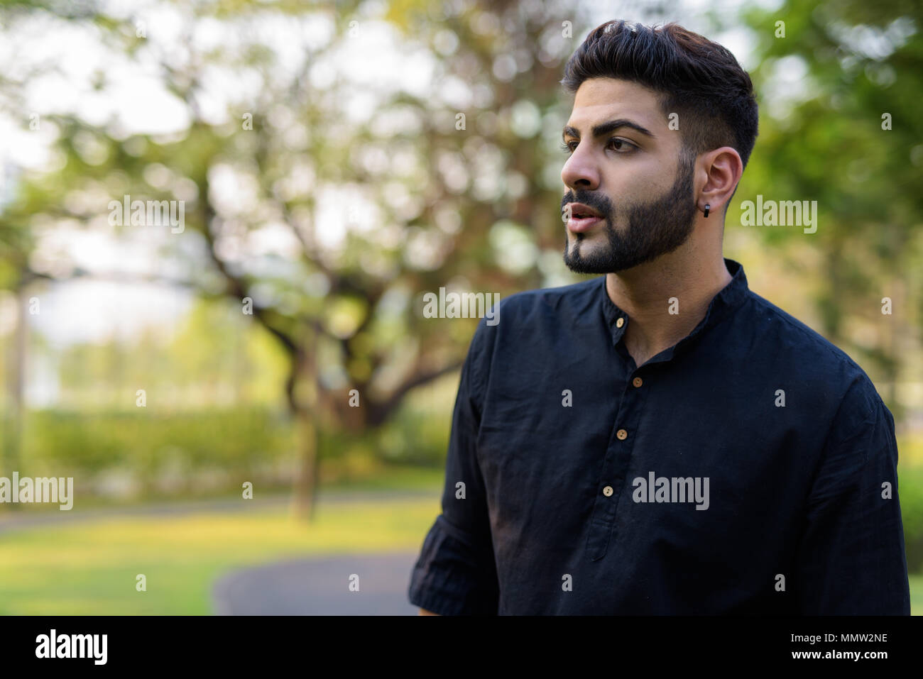 Close up of young handsome Indian man thinking while looking at Stock ...