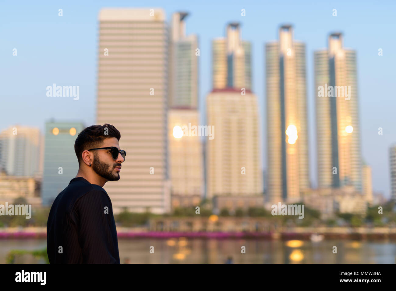 Profile view of young handsome Indian man thinking while wearing Stock ...