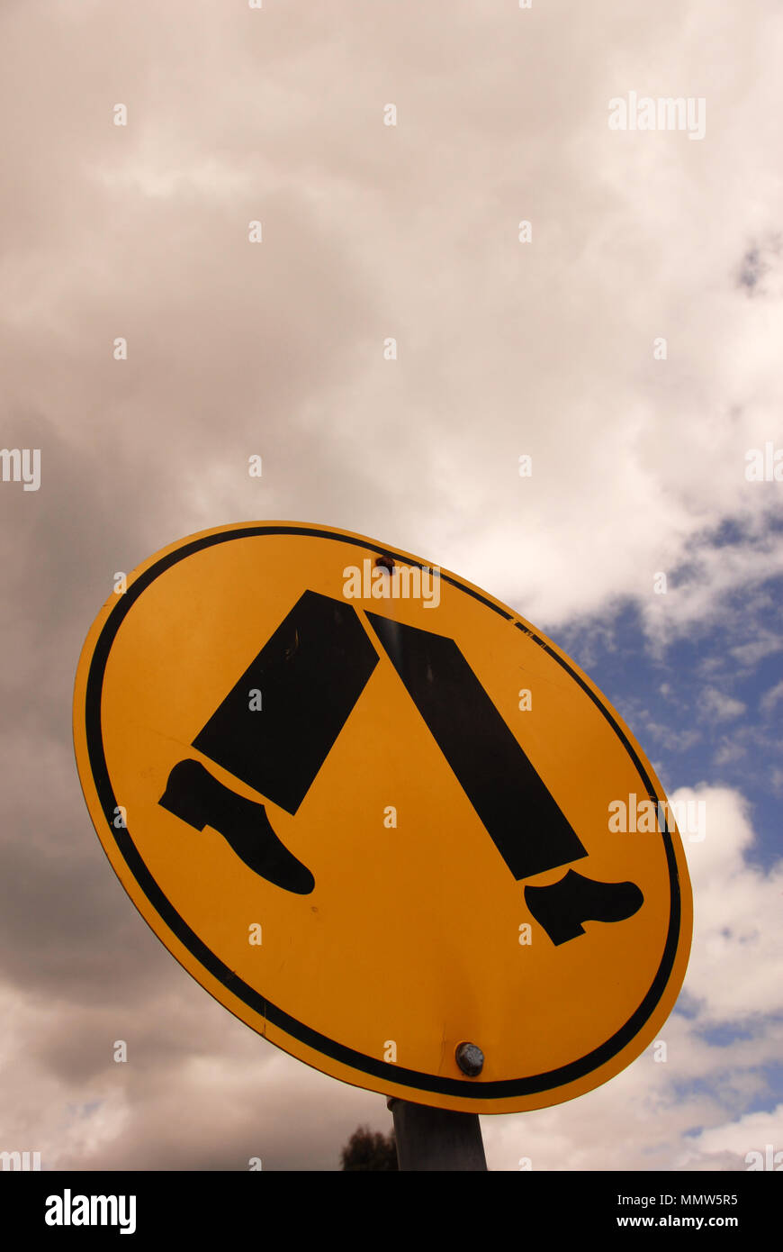 yellow circular public walking sign in Australia Stock Photo - Alamy