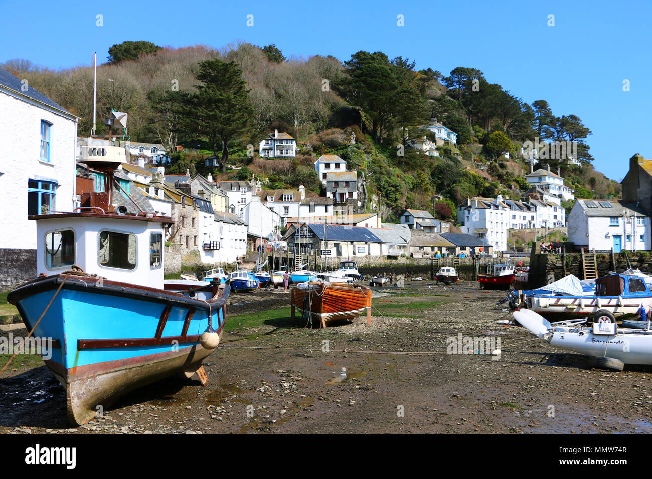 Moored boats with tide out in Cornish fishing village Stock Photo - Alamy
