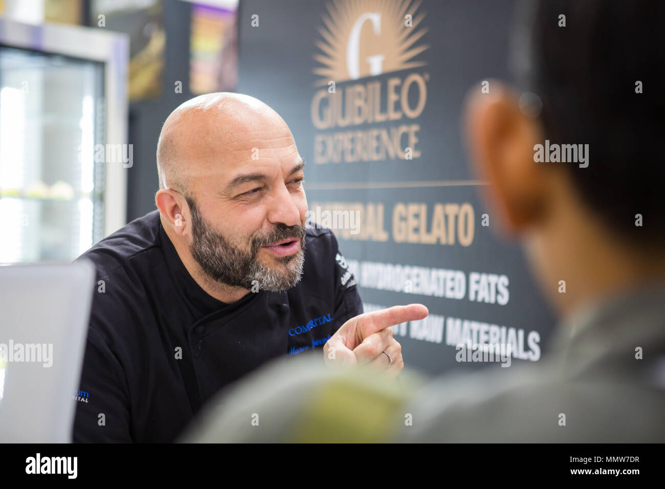 A bald man pointing finger action is an ice-cream chef interacting with ...