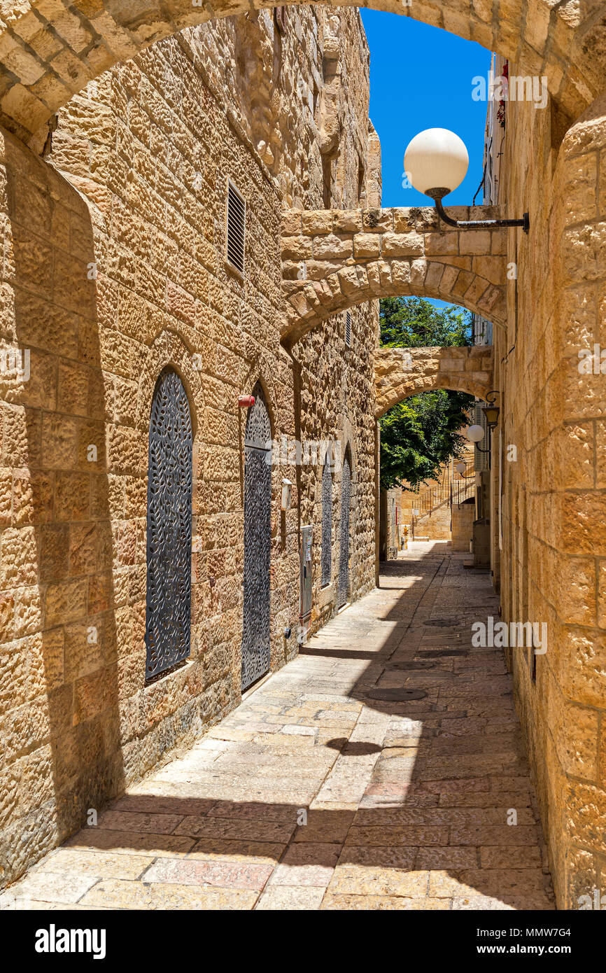 Narrow street among old stone houses in jewish quarter in Old City of ...
