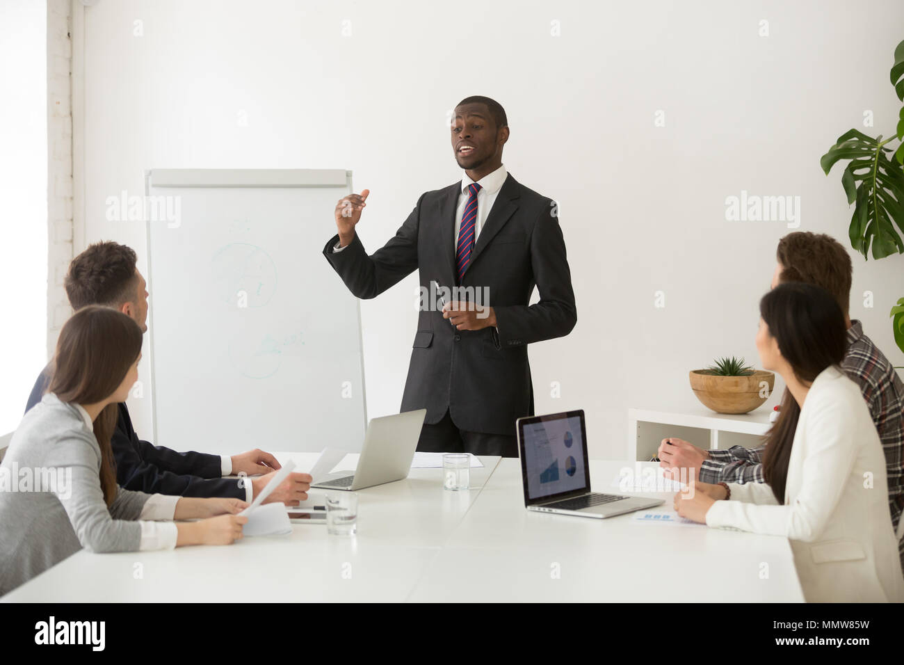 Confident african speaker or business coach giving presentation Stock ... Confident african speaker or business coach giving presentation Stock ...