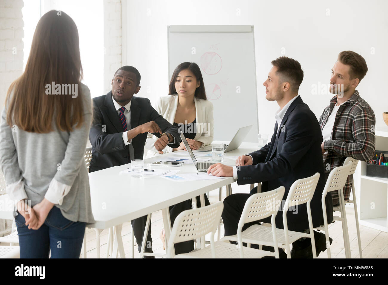 Angry african boss scolding employee for being late at meeting Stock ...