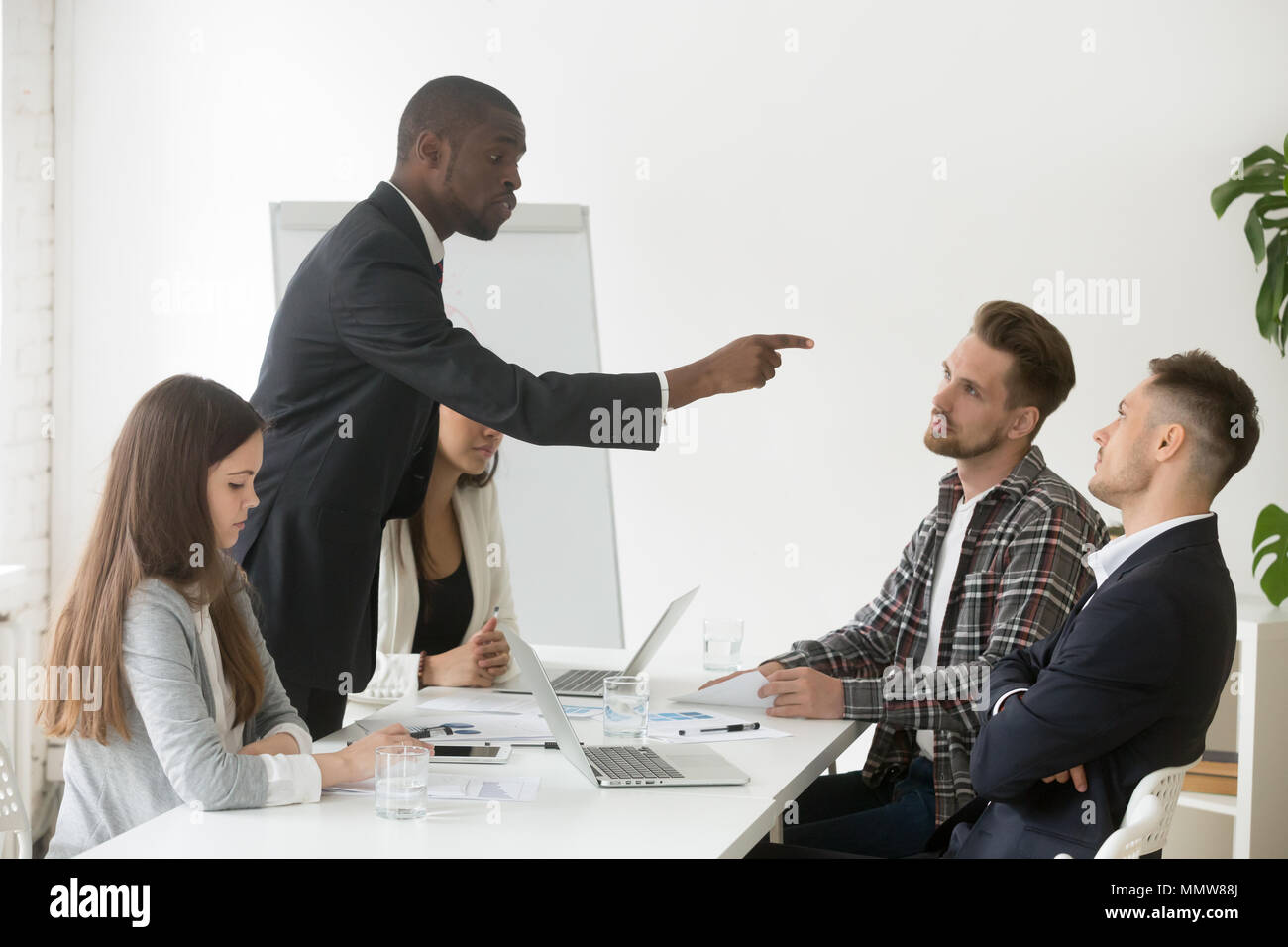 Angry rude african businessman pointing finger threatens colleag Stock ...