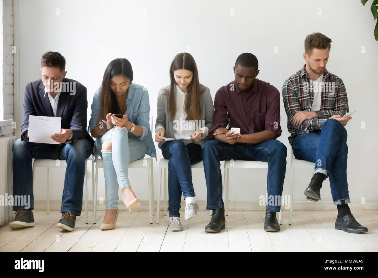 Multi-ethnic millennial people wait in queue preparing for job i Stock ...