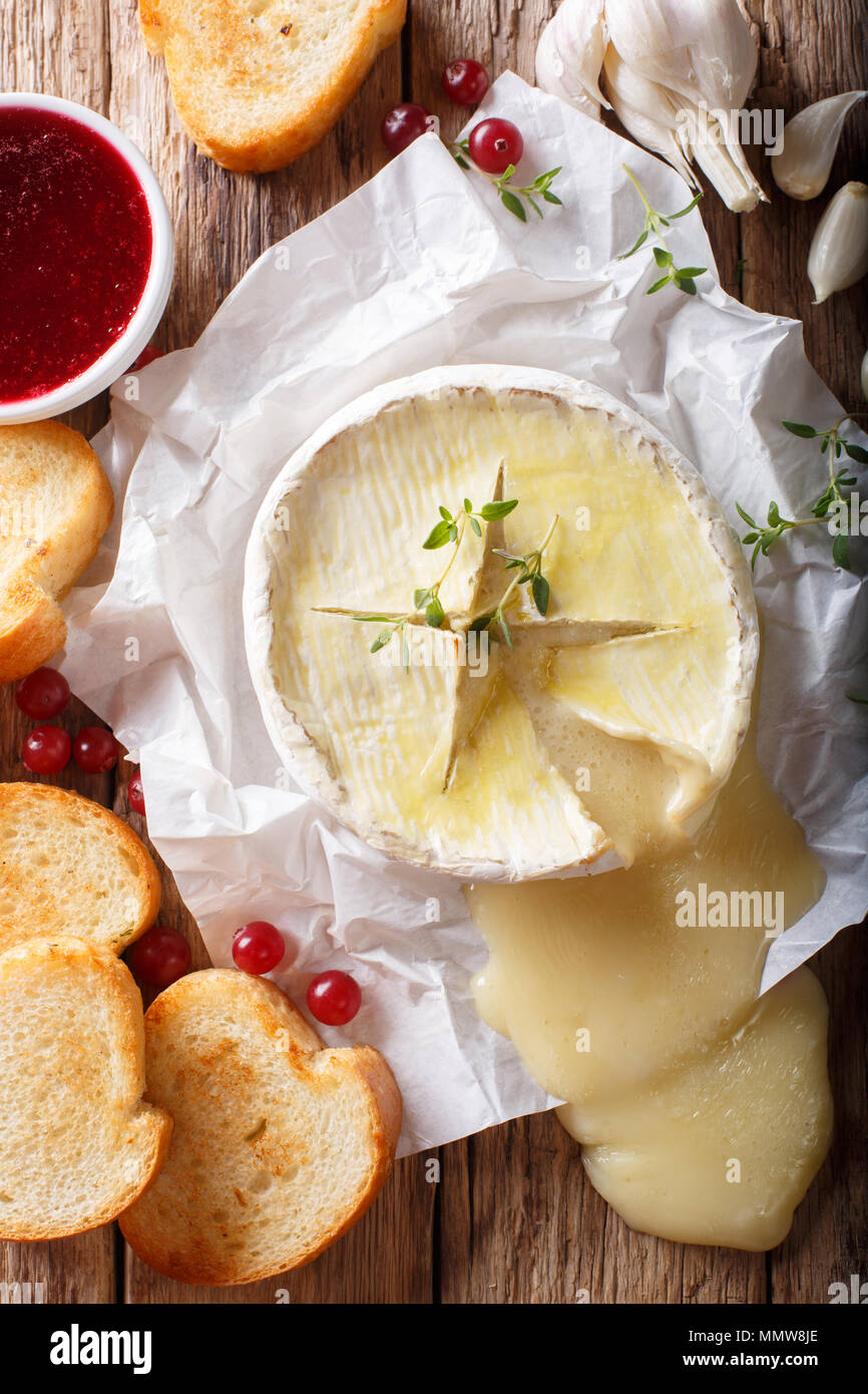French melted Camembert with toast and cranberry sauce close-up on the ...