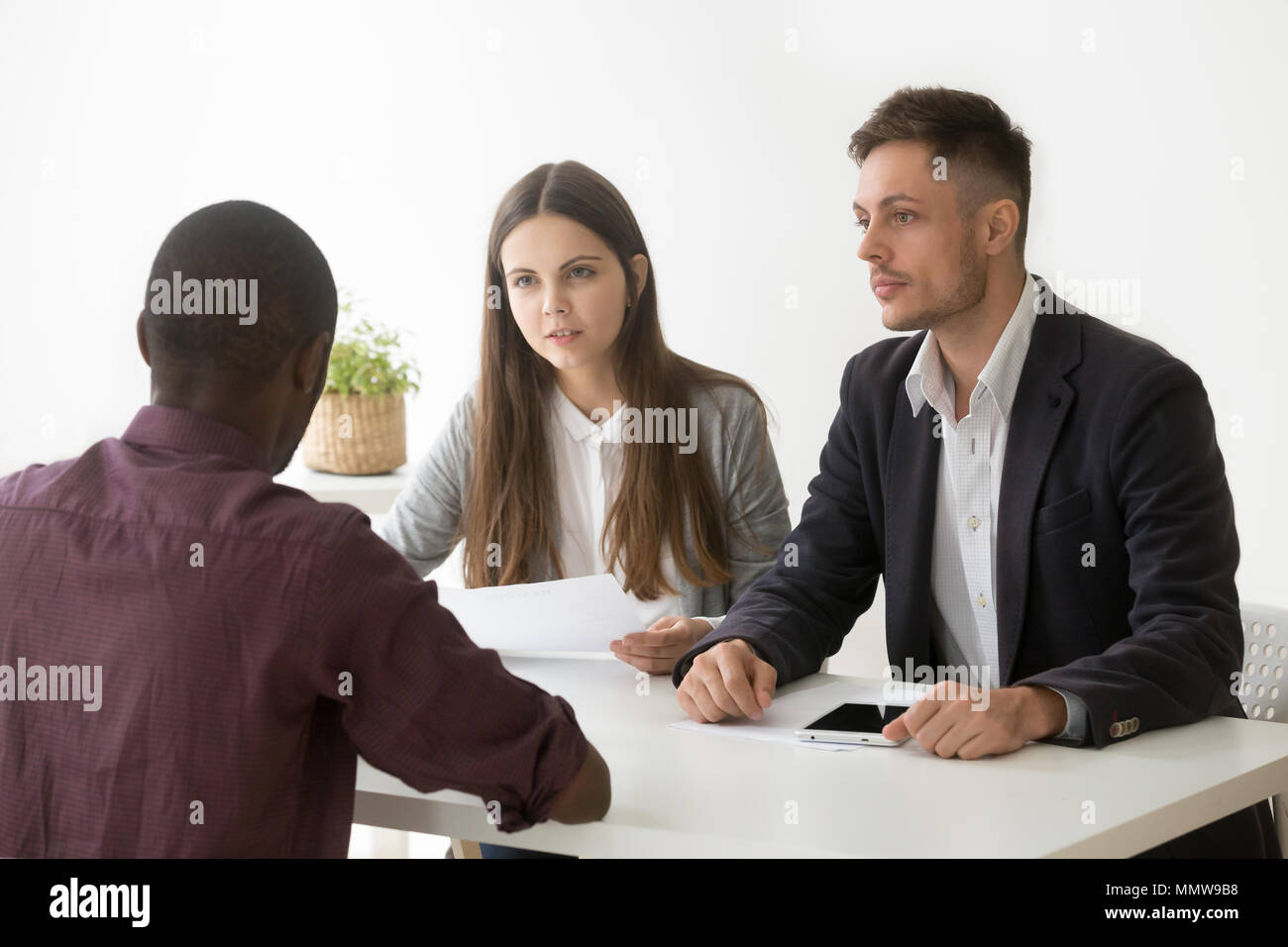 Black job interview serious hi-res stock photography and images - Alamy