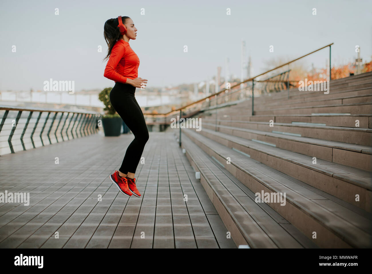 Fitness woman jumping outdoor in urban enviroment Stock Photo - Alamy