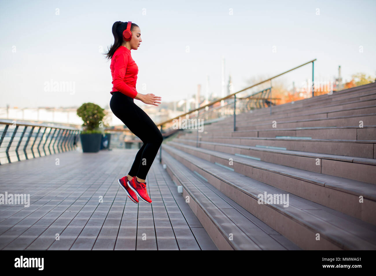 Fitness woman jumping outdoor in urban enviroment Stock Photo - Alamy