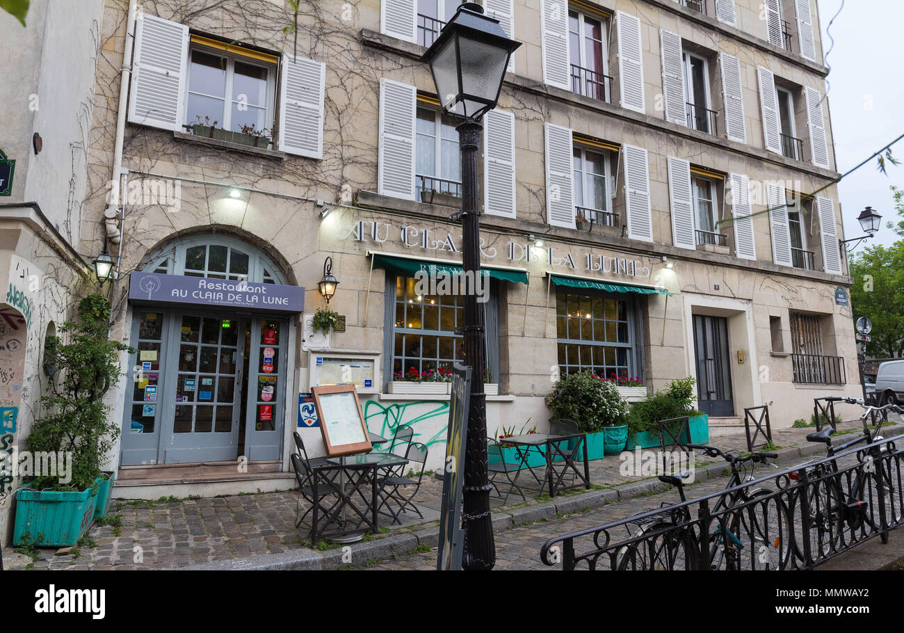 The French traditional cafe Au clair de la lune at night, Paris, France ...