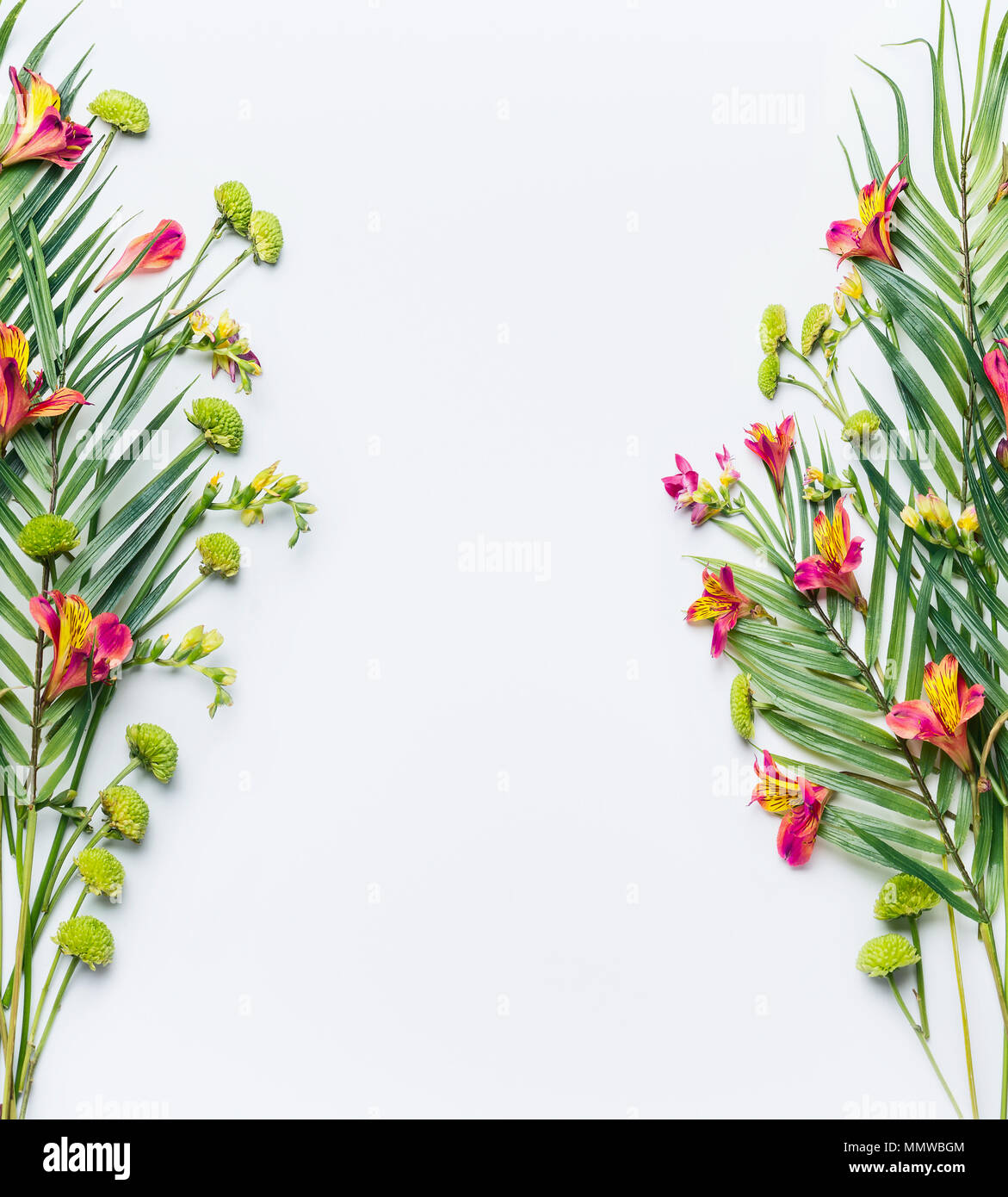 Summer tropical design frame with green palm leaves and exotic flowers ...