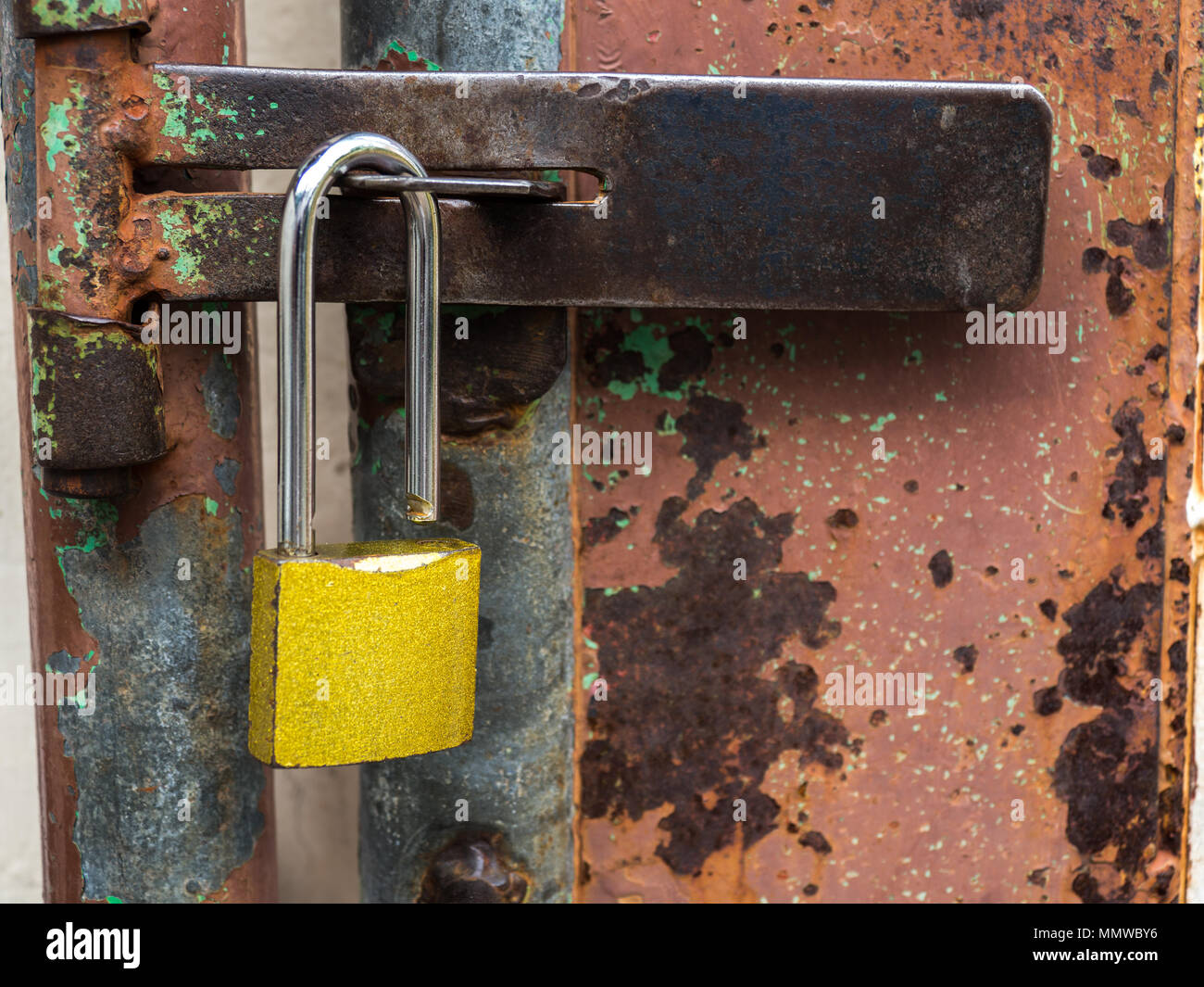Golden lock at the rusted steel door Stock Photo - Alamy