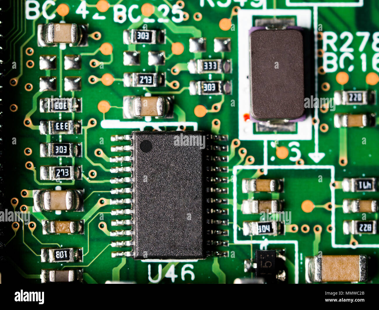 close-up of circuit board with integrated circuits, resistors and ...