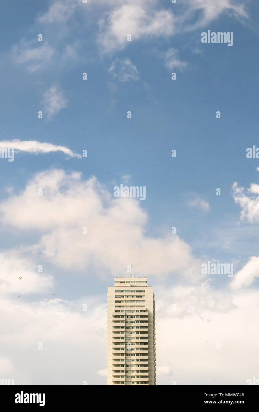 Single modern tall building against blue sky with copy space Stock ...