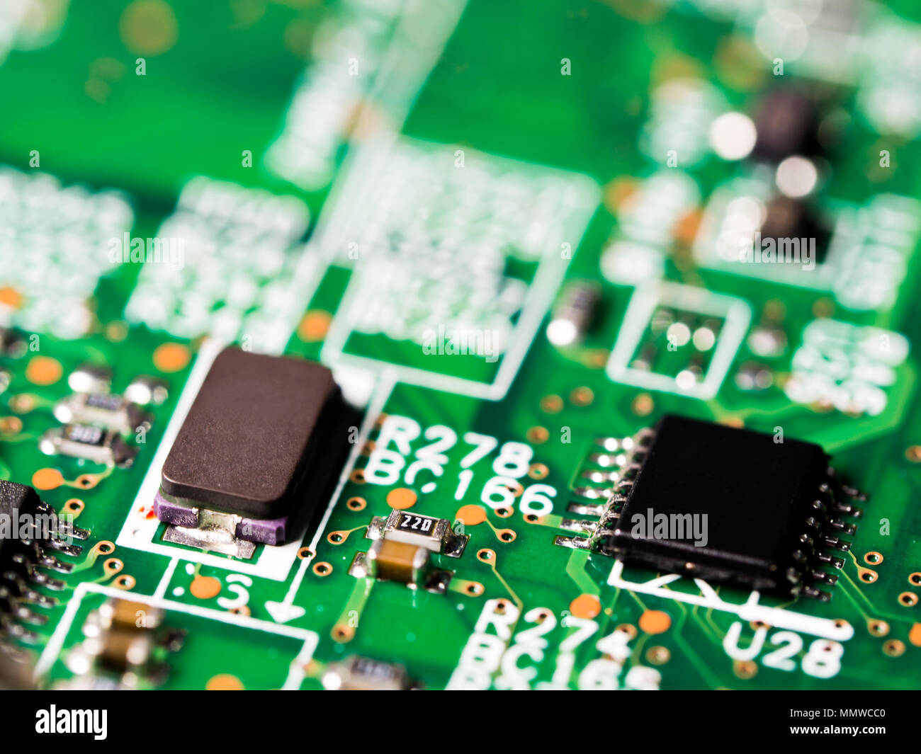 close-up of circuit board with integrated circuits, resistors and ...