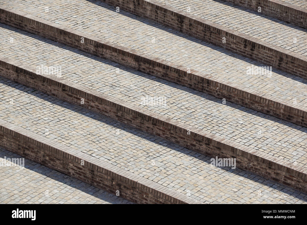 Abstract diagonal stairs, old worn granite staircase on a city square ...