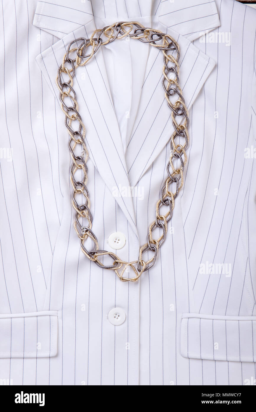 Close up female blazer and chain Stock Photo - Alamy