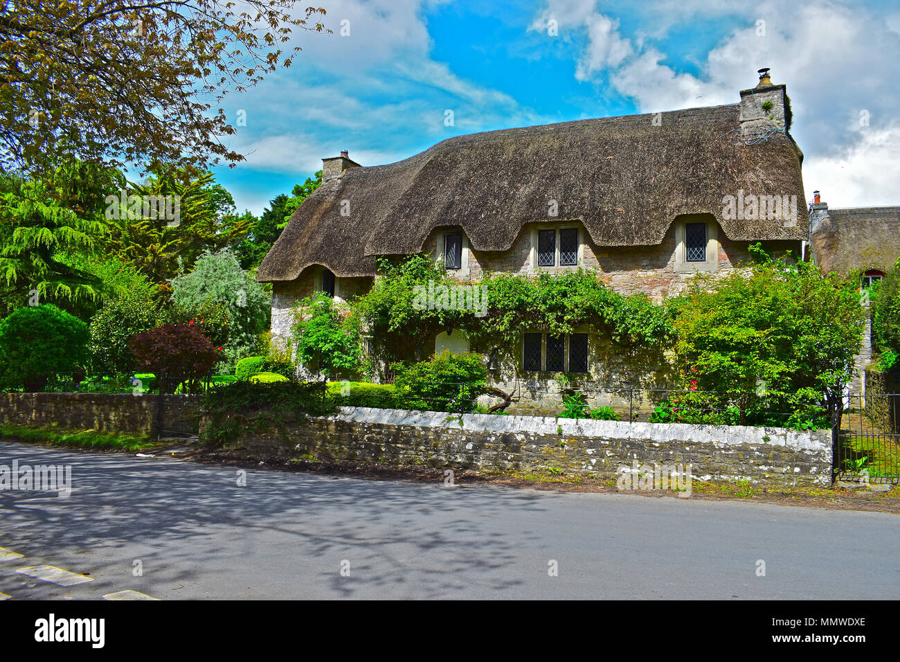 The pretty thatched roof cottage known as Church Cottage, in the small ...