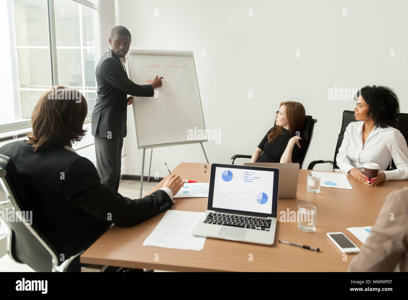 African-american businessman giving presentation explaining new Stock ...