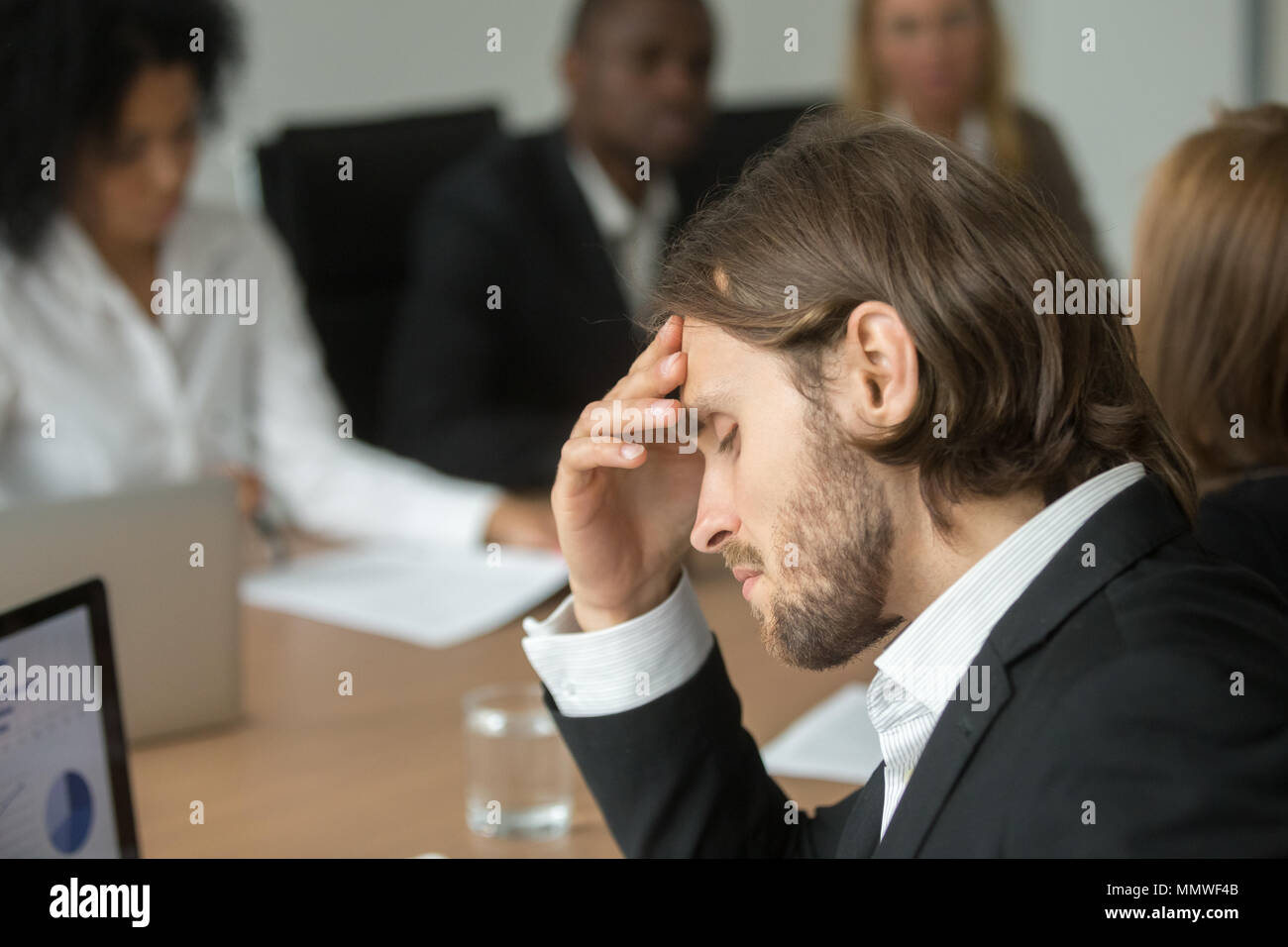 Frustrated tired businessman having strong headache at diverse t Stock ...