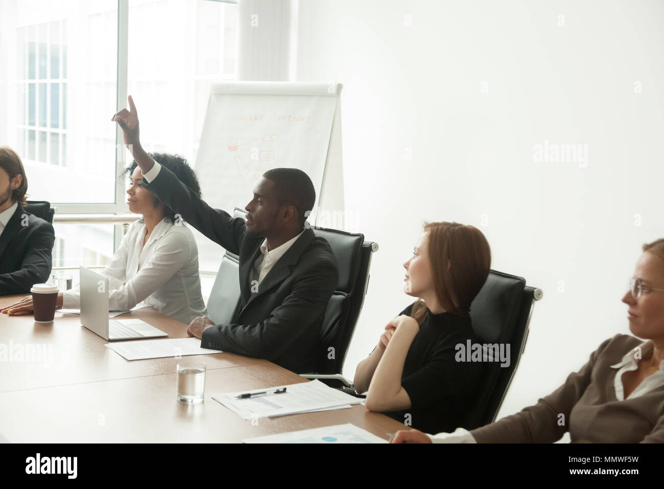 African-american businessman volunteer raising hand at corporate Stock ...