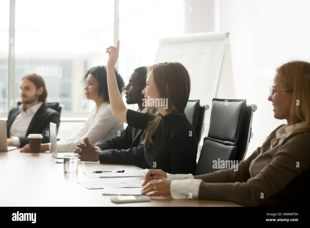 Businesswoman raising hand hi-res stock photography and images - Alamy