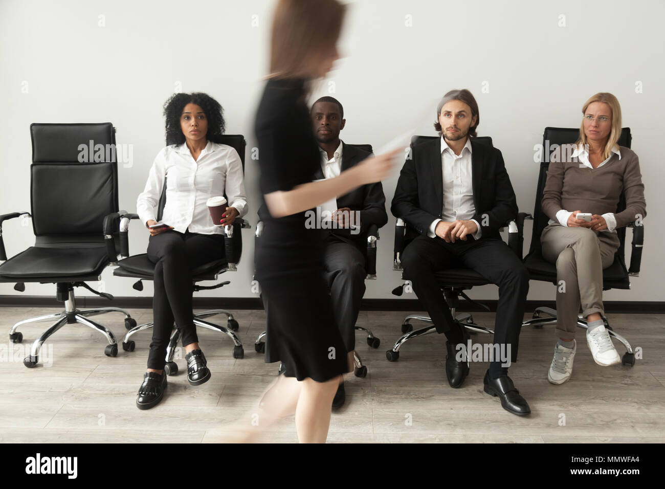 Stressed applicants sitting in queue watching rival after job in Stock ...